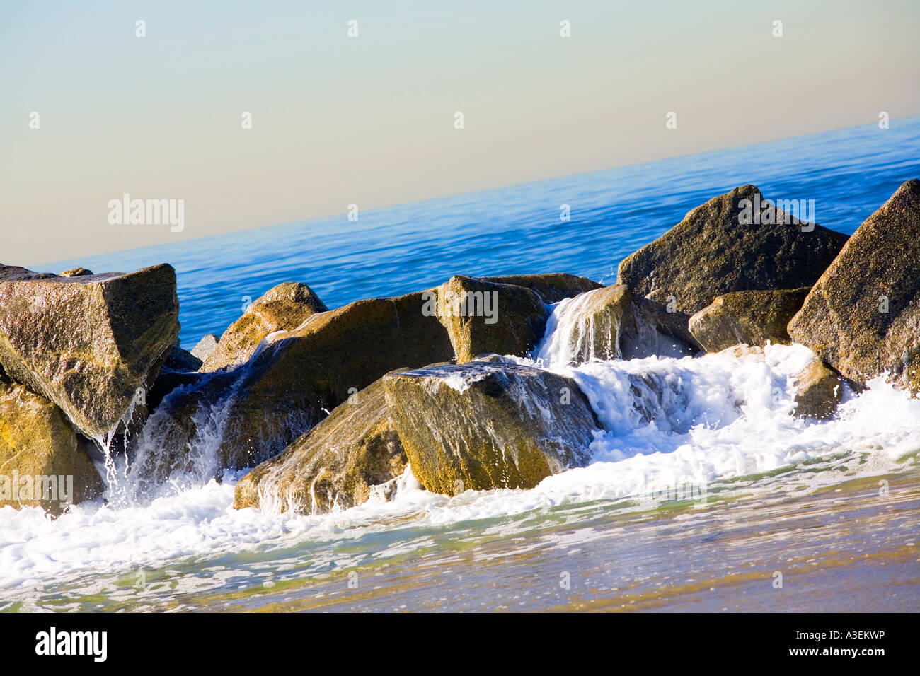 Ocean pouring over rocks Stock Photo - Alamy