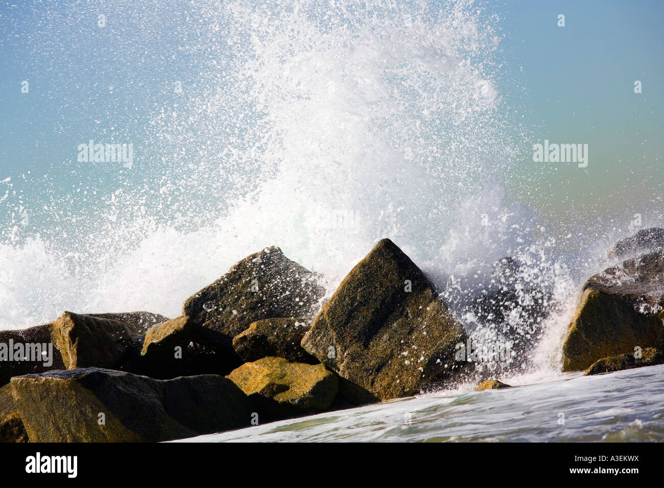 Waves crashing into beach barriers hi-res stock photography and images ...