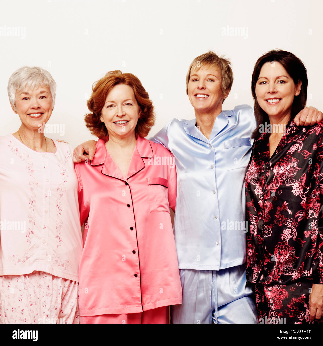 Portrait of three mature women and a senior woman standing together and ...
