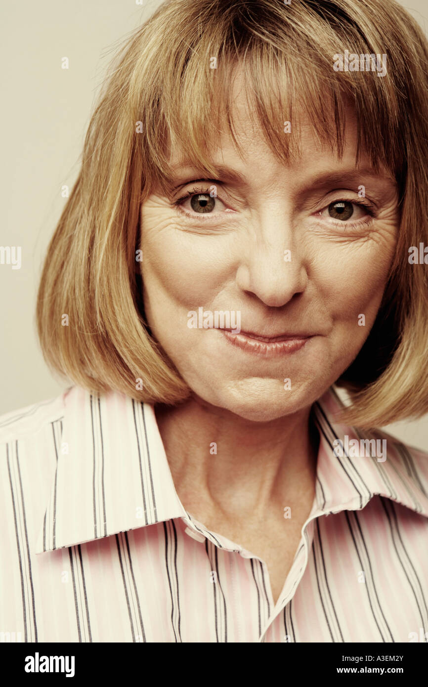 Portrait of a mature woman smirking Stock Photo - Alamy