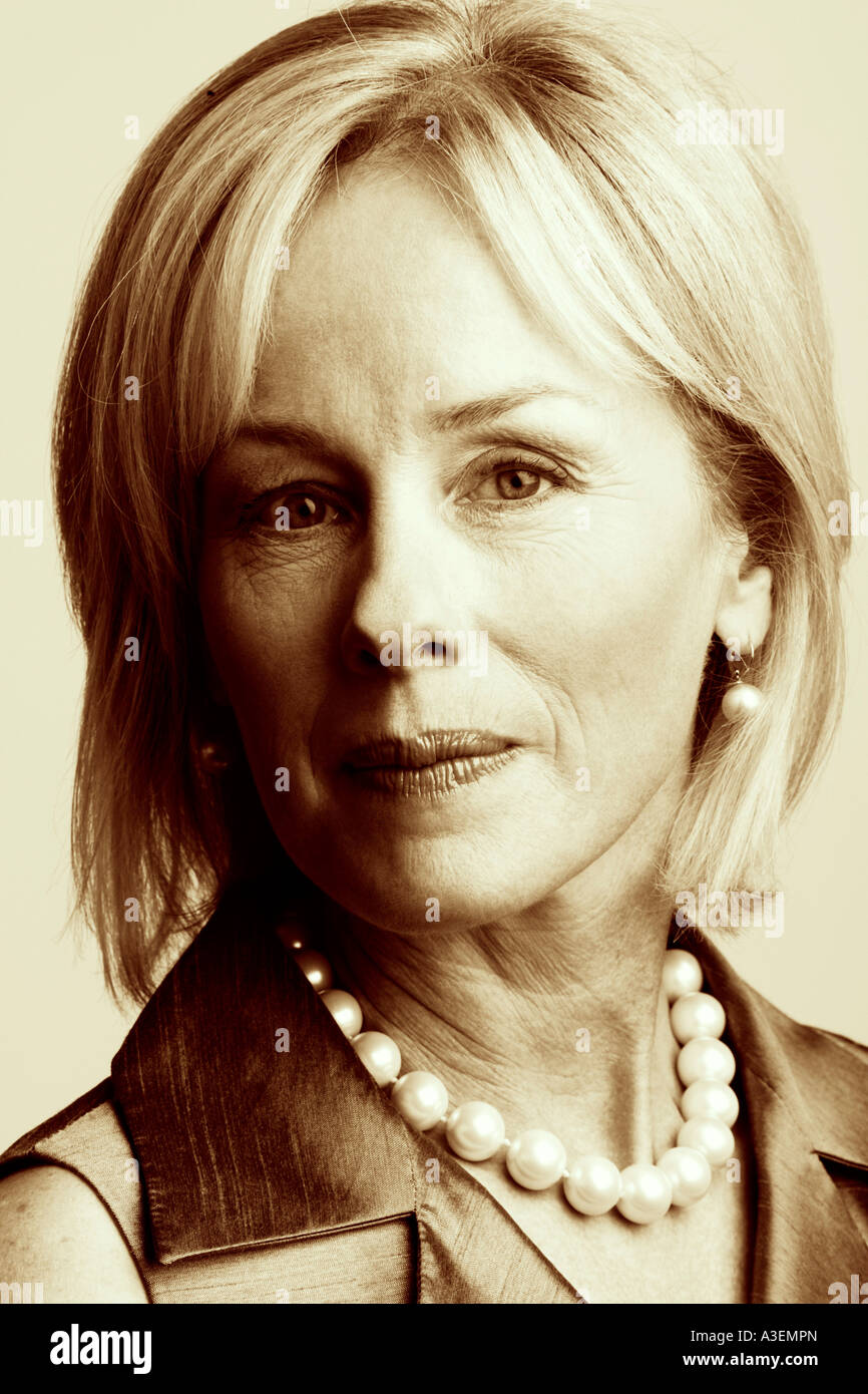 Portrait of a mature woman smirking Stock Photo - Alamy