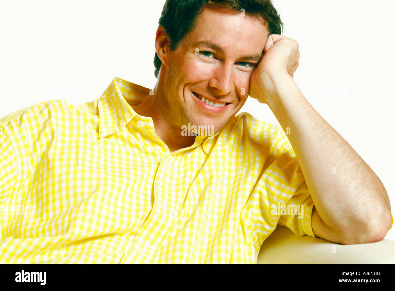 Portrait of a mid adult man smiling with his head in his hands Stock ...