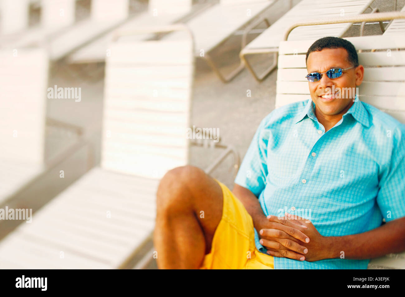 Mature man reclining on a lounge chair Stock Photo - Alamy