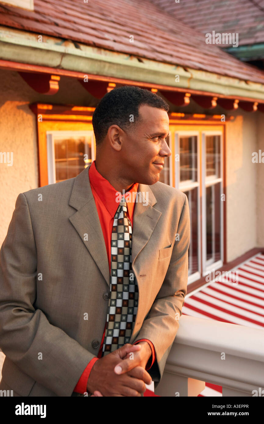 Mature man leaning against a balustrade Stock Photo - Alamy