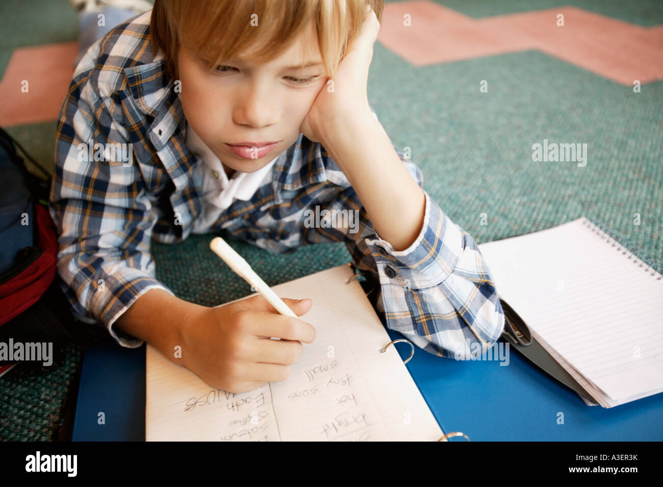 Boy doing homework Stock Photo - Alamy