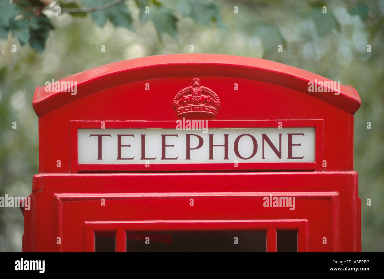 An image of the top quarter of a traditional red British telephone box ...