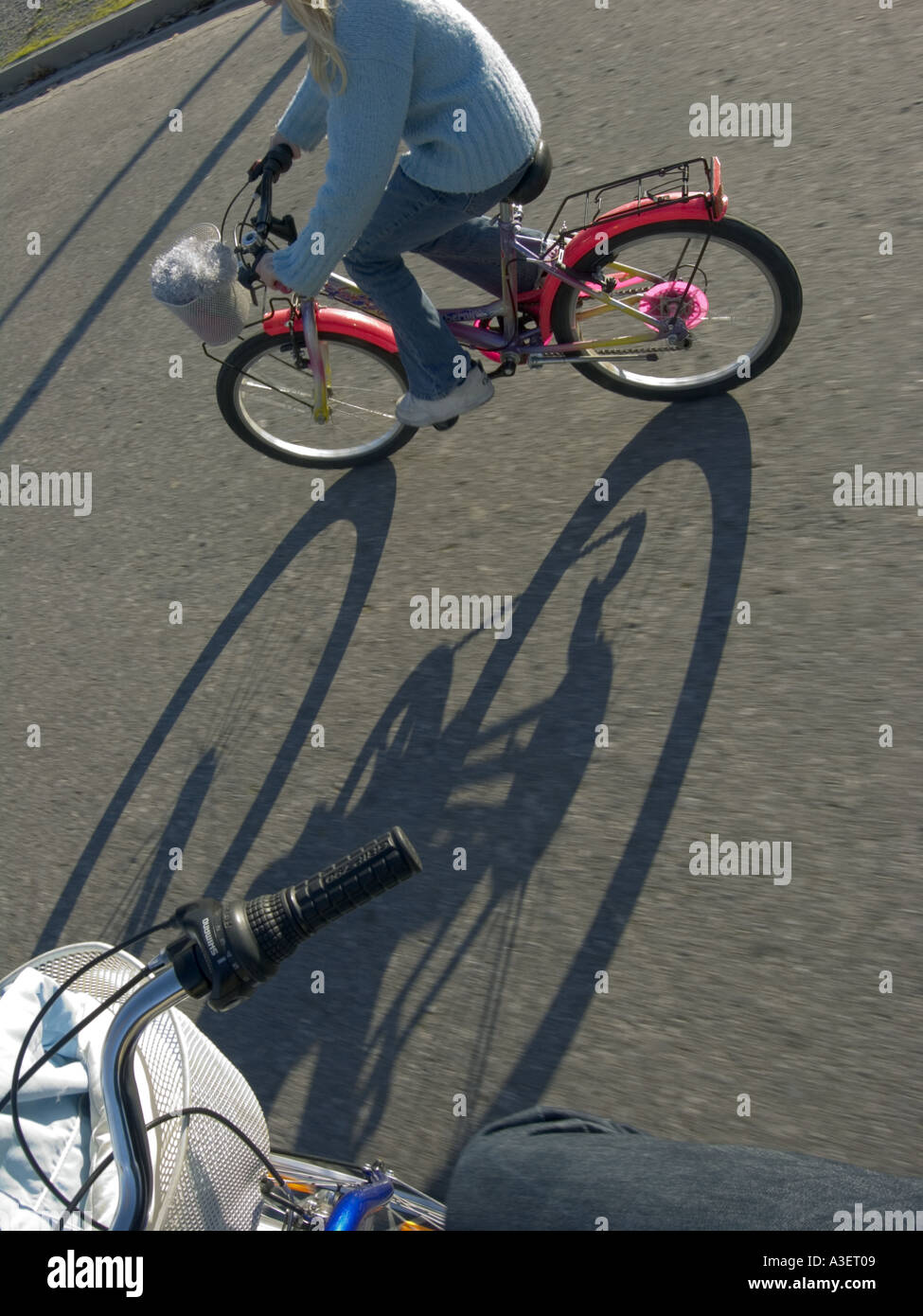 small child riding bike shadows on the road Stock Photo - Alamy