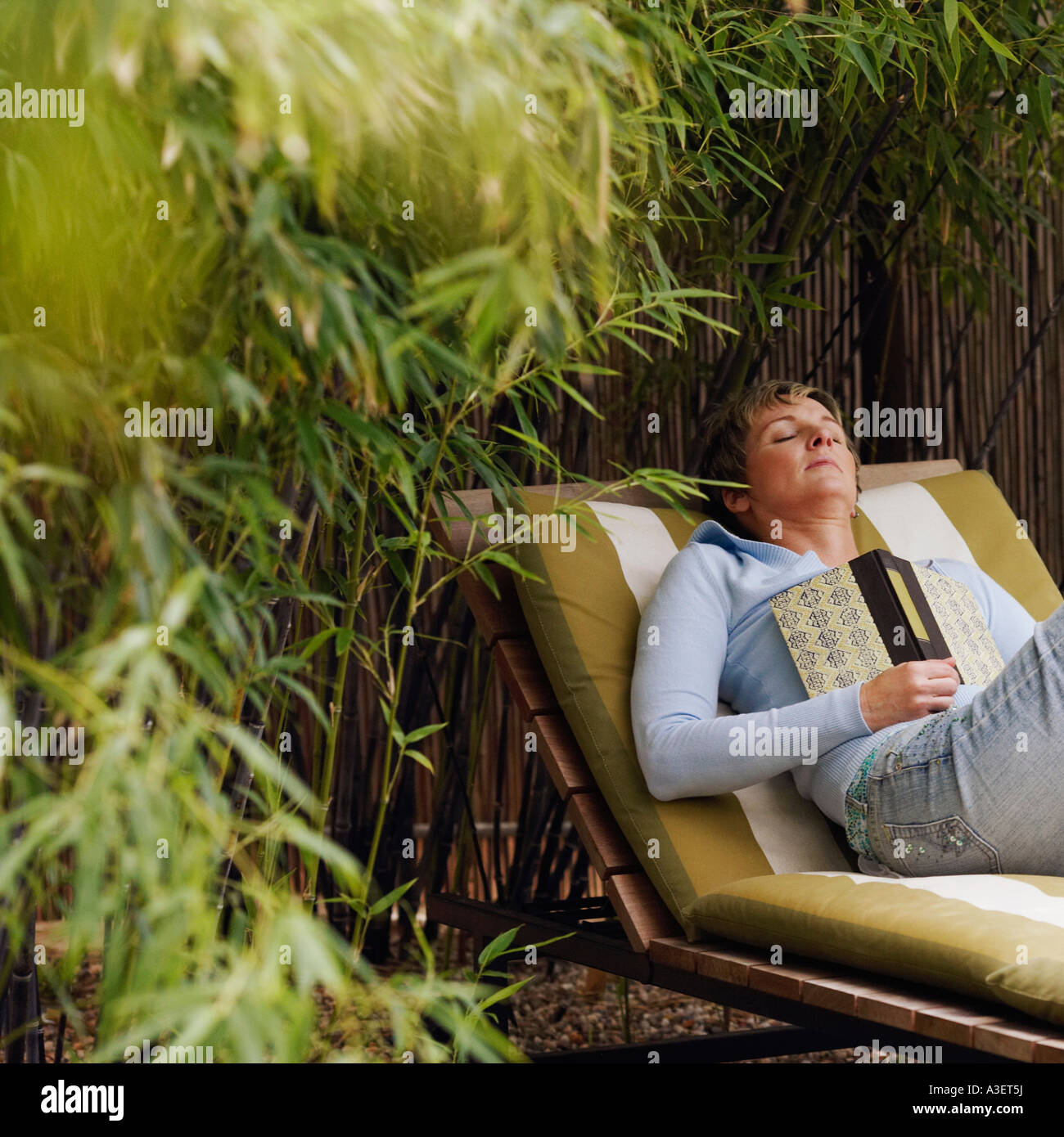 Woman sleeping on lounge chair hi-res stock photography and images - Alamy