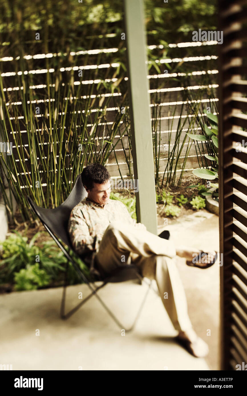 High angle view of a mature man sitting on a chair Stock Photo - Alamy