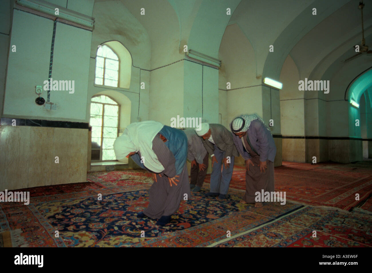 Four men praying in a mosque Baghdad Iraq Stock Photo - Alamy
