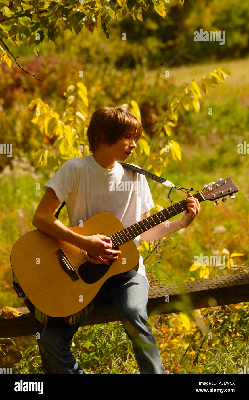 Teen playing guitar Stock Photo - Alamy