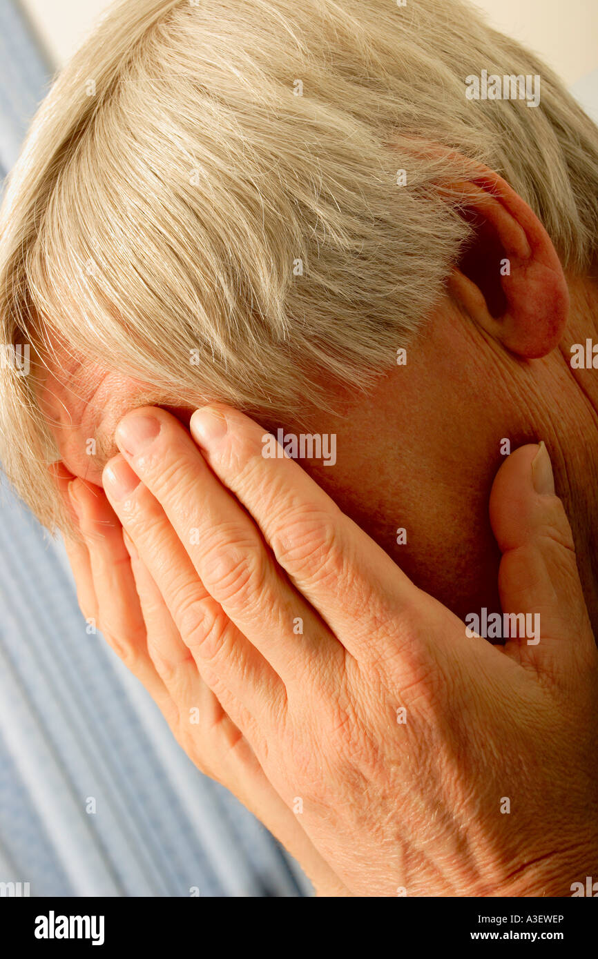 Man with head in his hands Stock Photo - Alamy