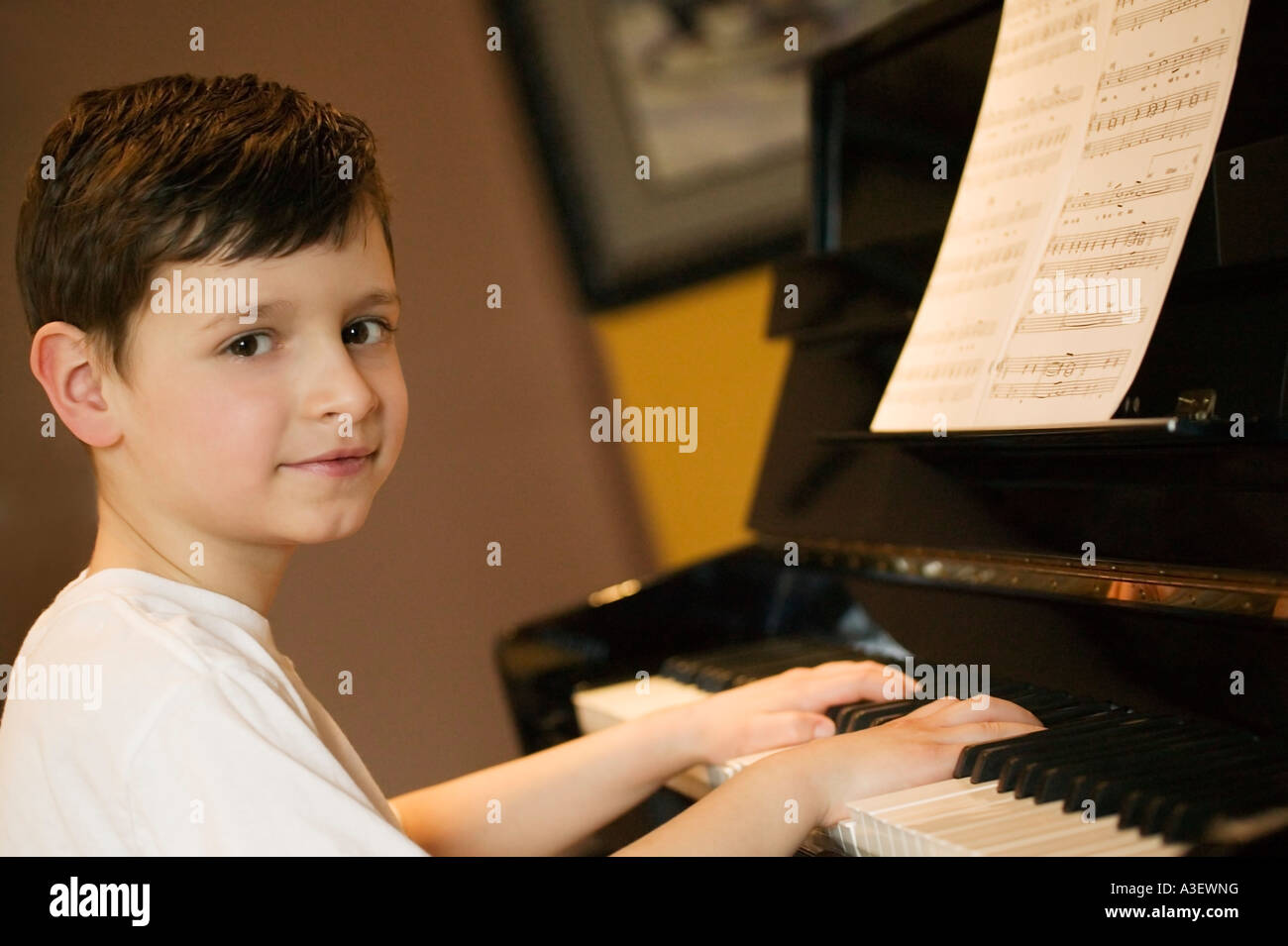 Young boy playing piano Stock Photo - Alamy
