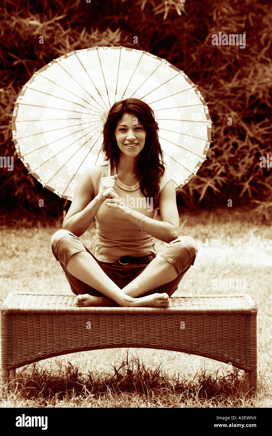 Portrait of a mature woman holding a parasol and smiling Stock Photo ...