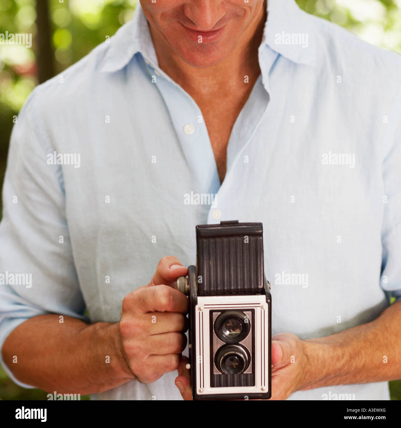Mature man holding a camera Stock Photo - Alamy