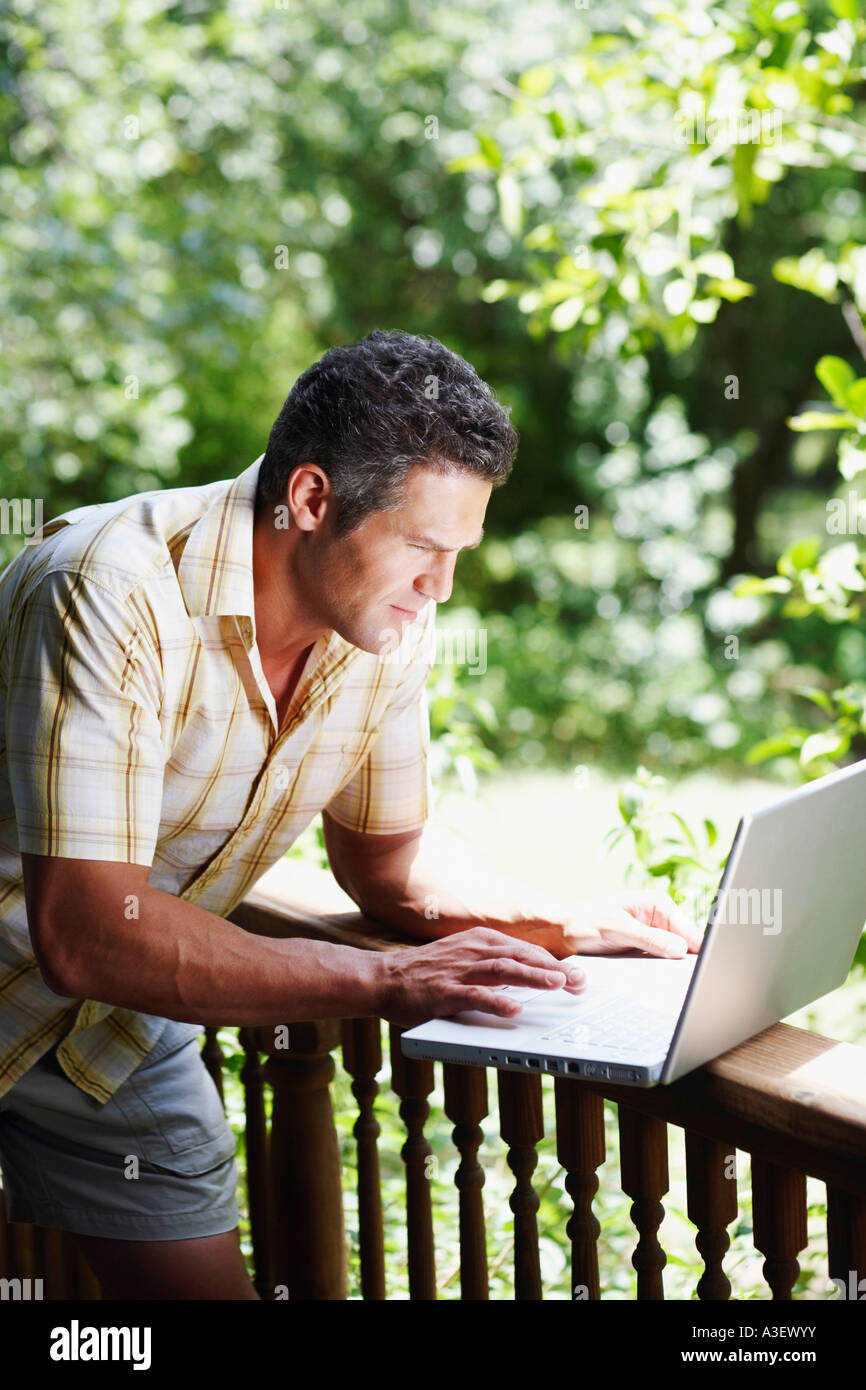 Side profile of a mid adult man using a laptop Stock Photo - Alamy