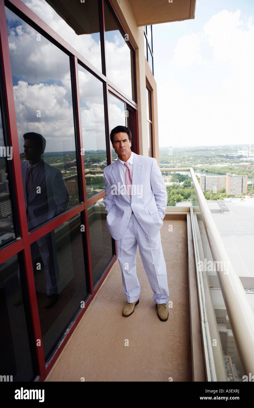 Portrait of a businessman standing in a balcony Stock Photo - Alamy