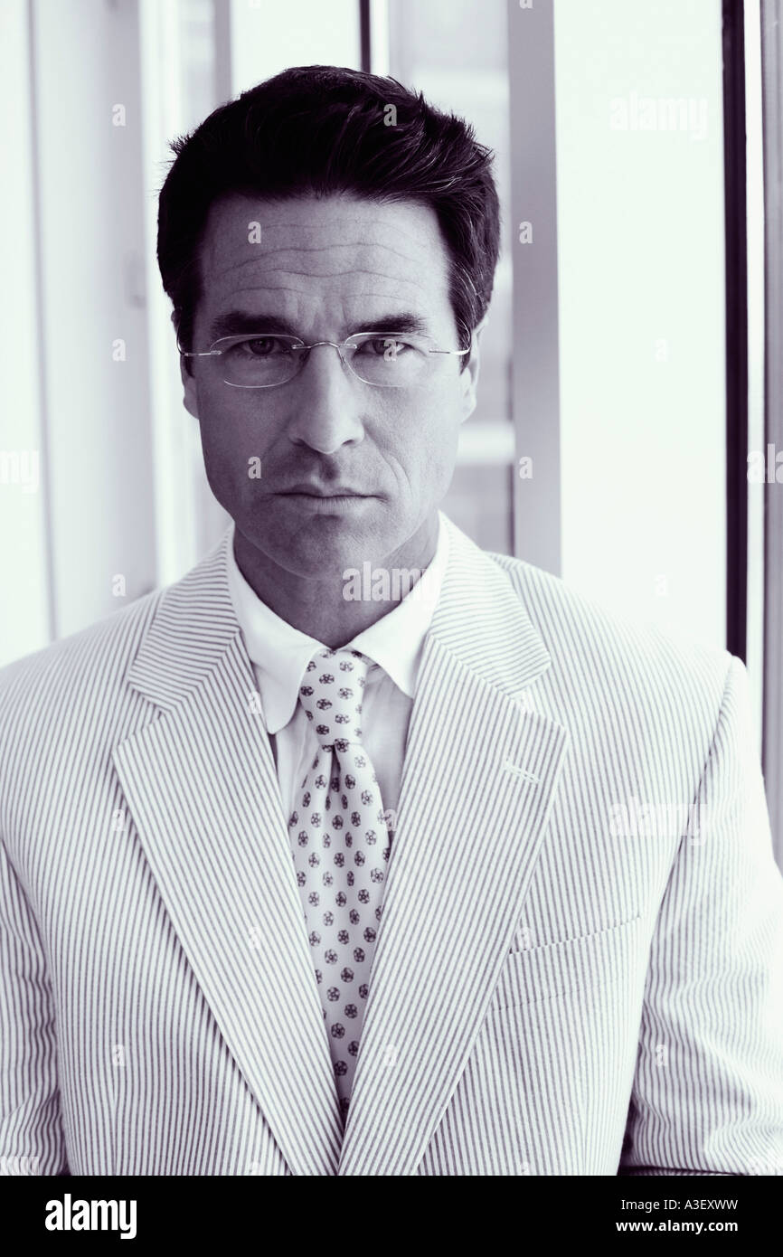 Portrait of a businessman looking serious Stock Photo - Alamy