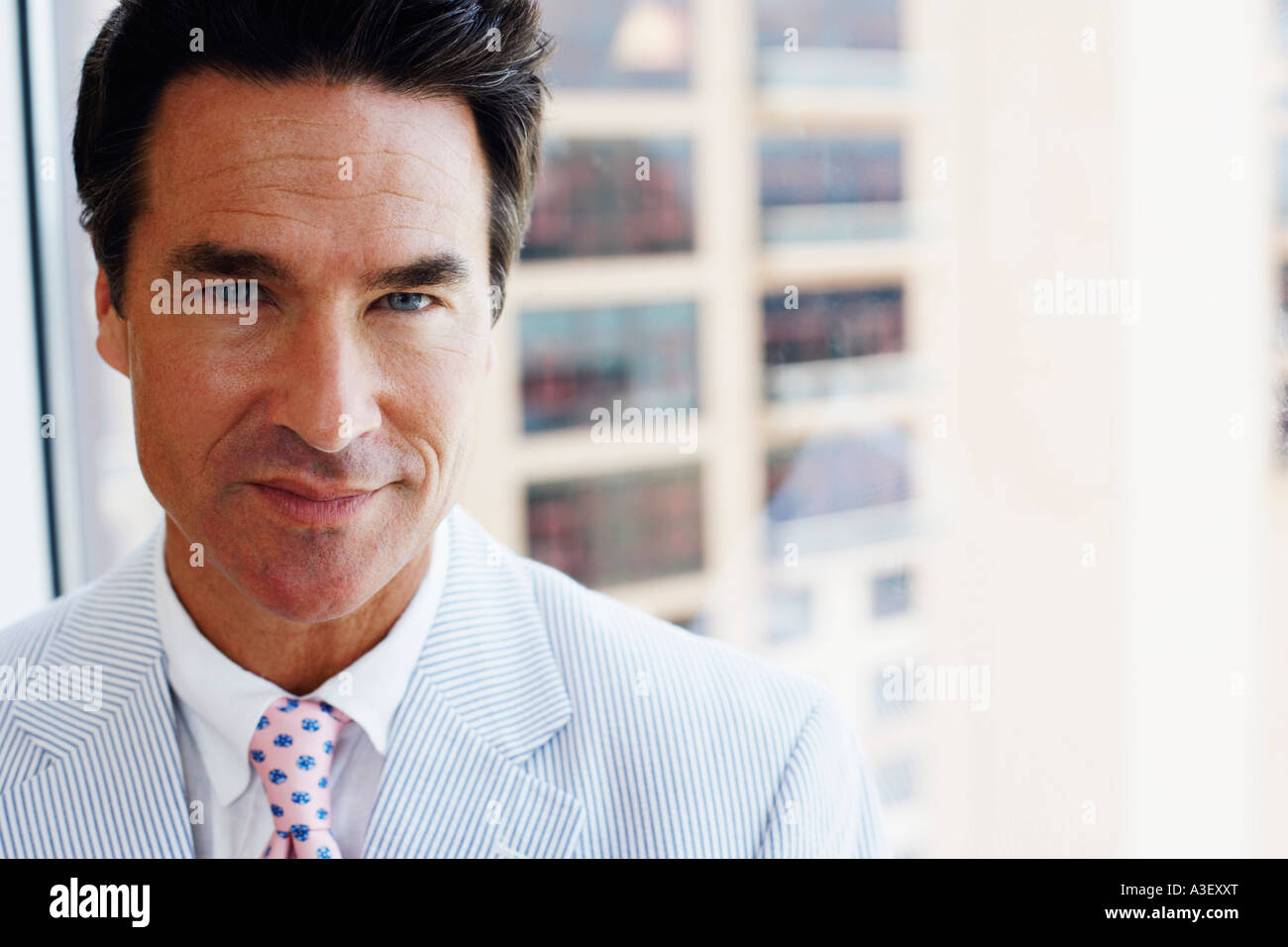 Portrait of a businessman smirking Stock Photo - Alamy