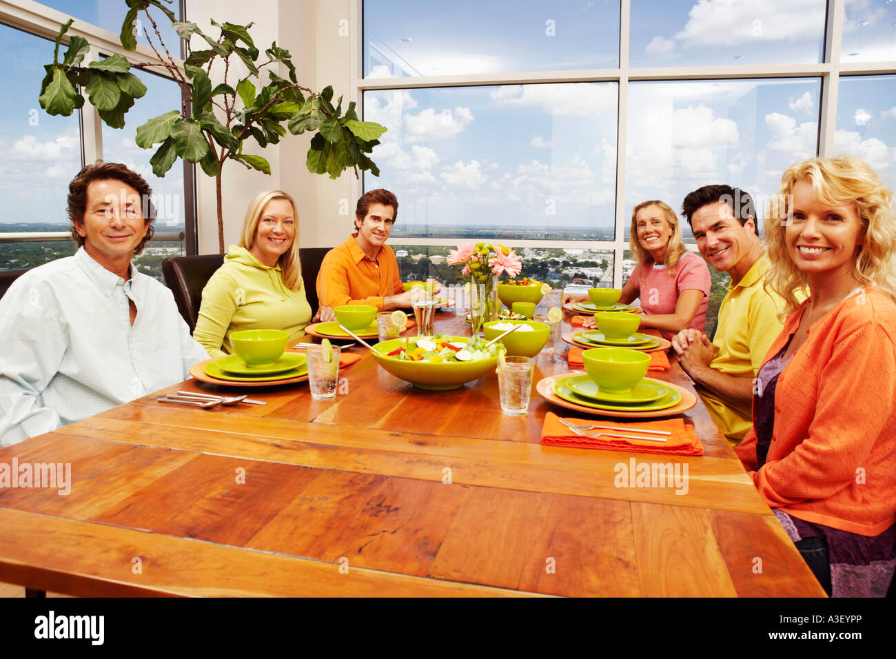 Portrait of a group of people sitting at a dining table Stock Photo - Alamy