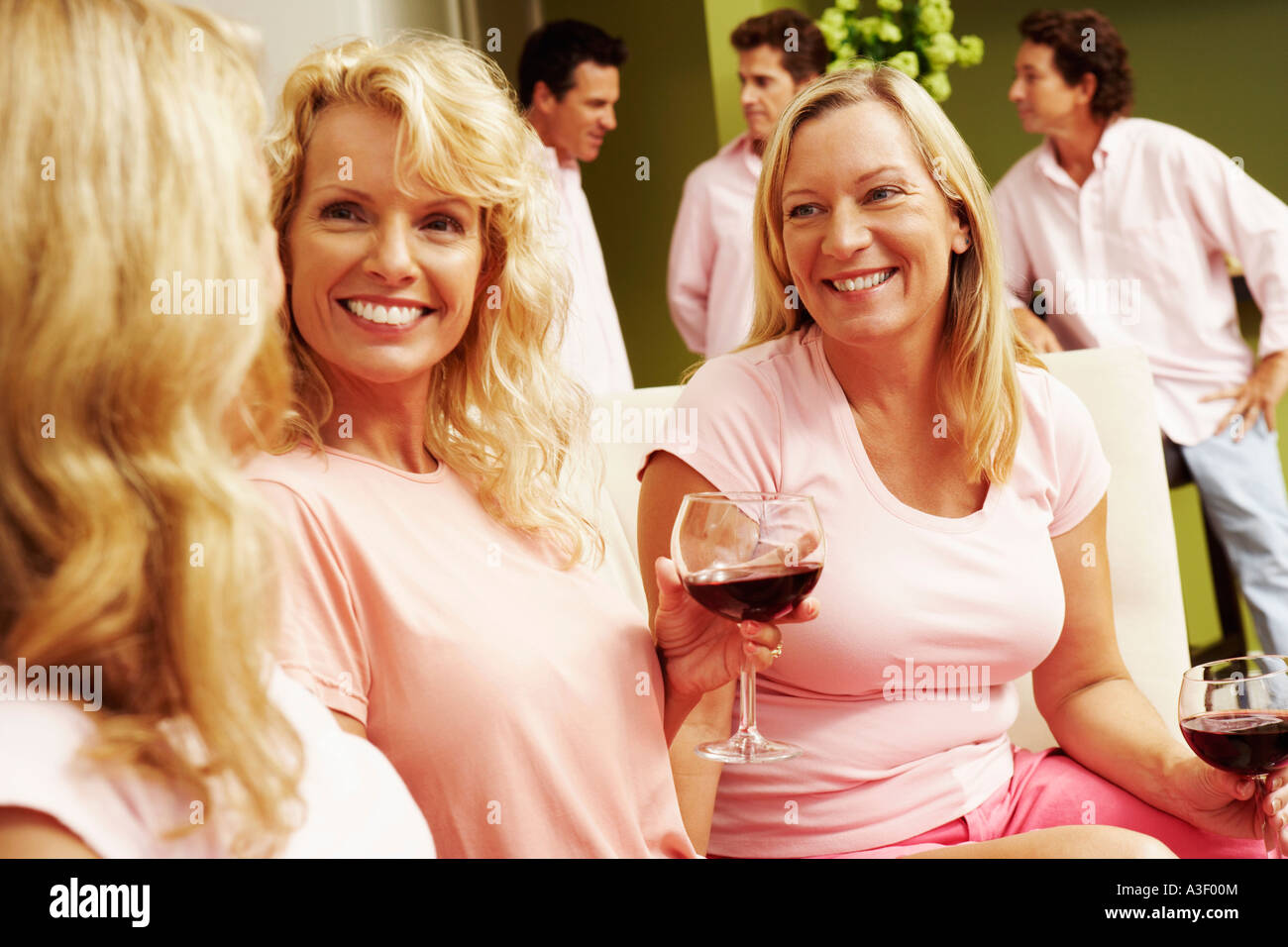 Three women sitting together and smiling Stock Photo - Alamy