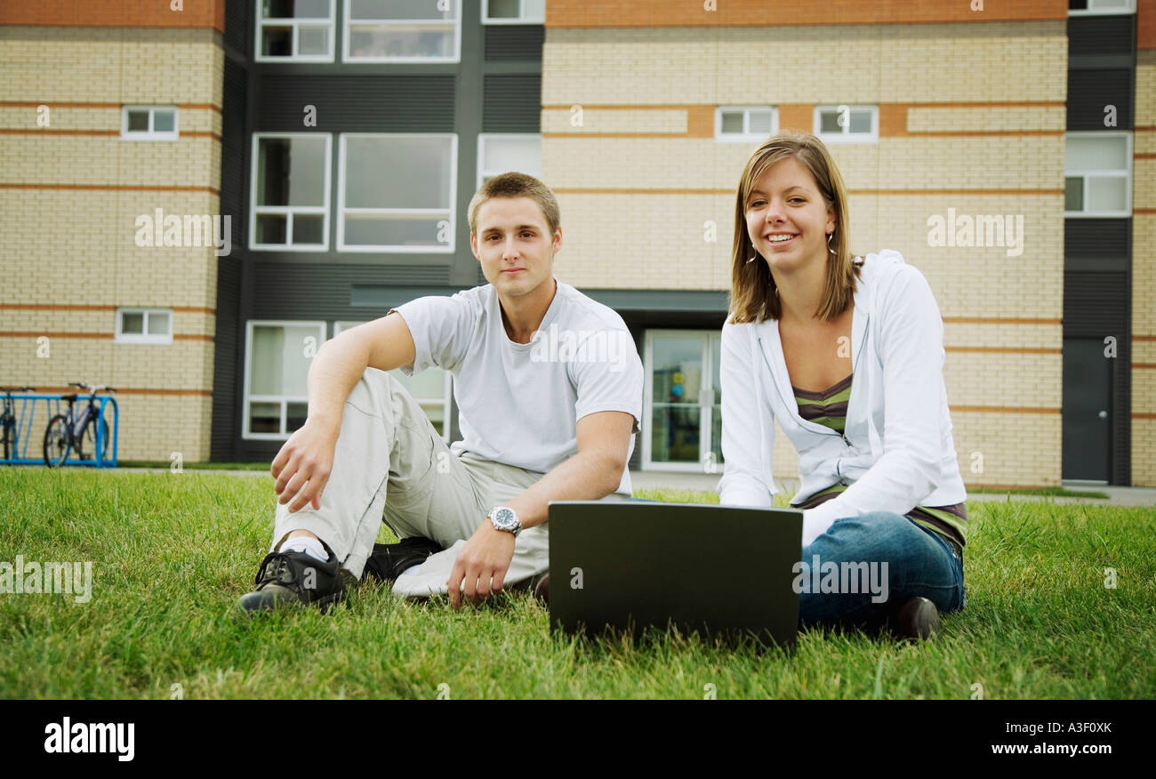 Friends using a laptop Stock Photo - Alamy