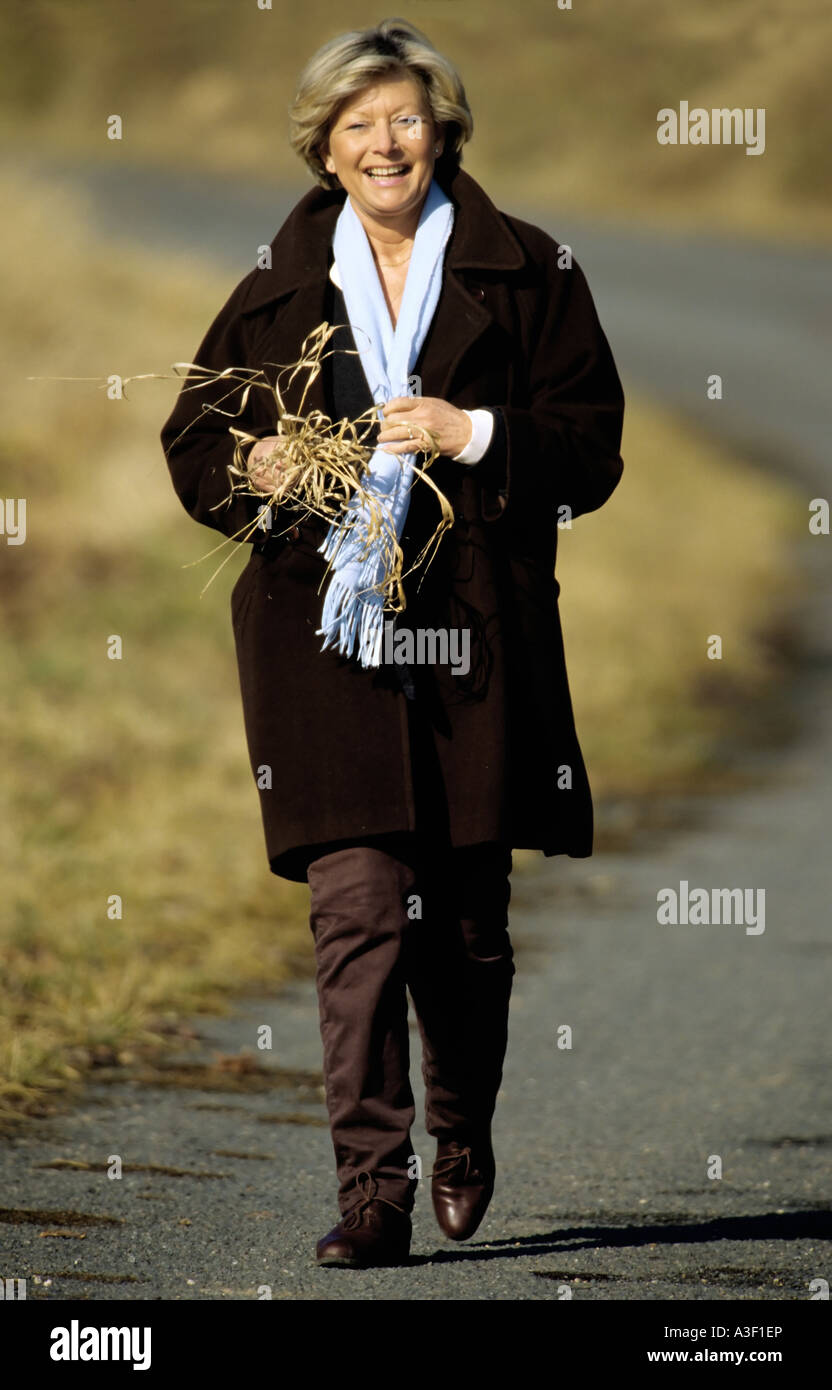 Smiing mature woman strolling hi-res stock photography and images - Alamy