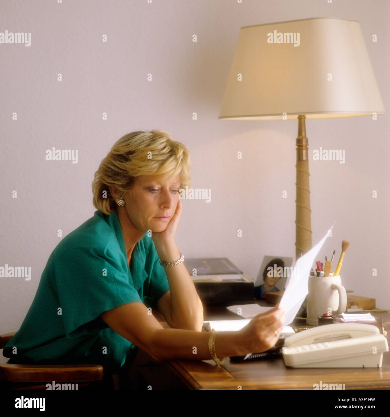 MR MATURE WOMAN READING AT DESK Stock Photo - Alamy