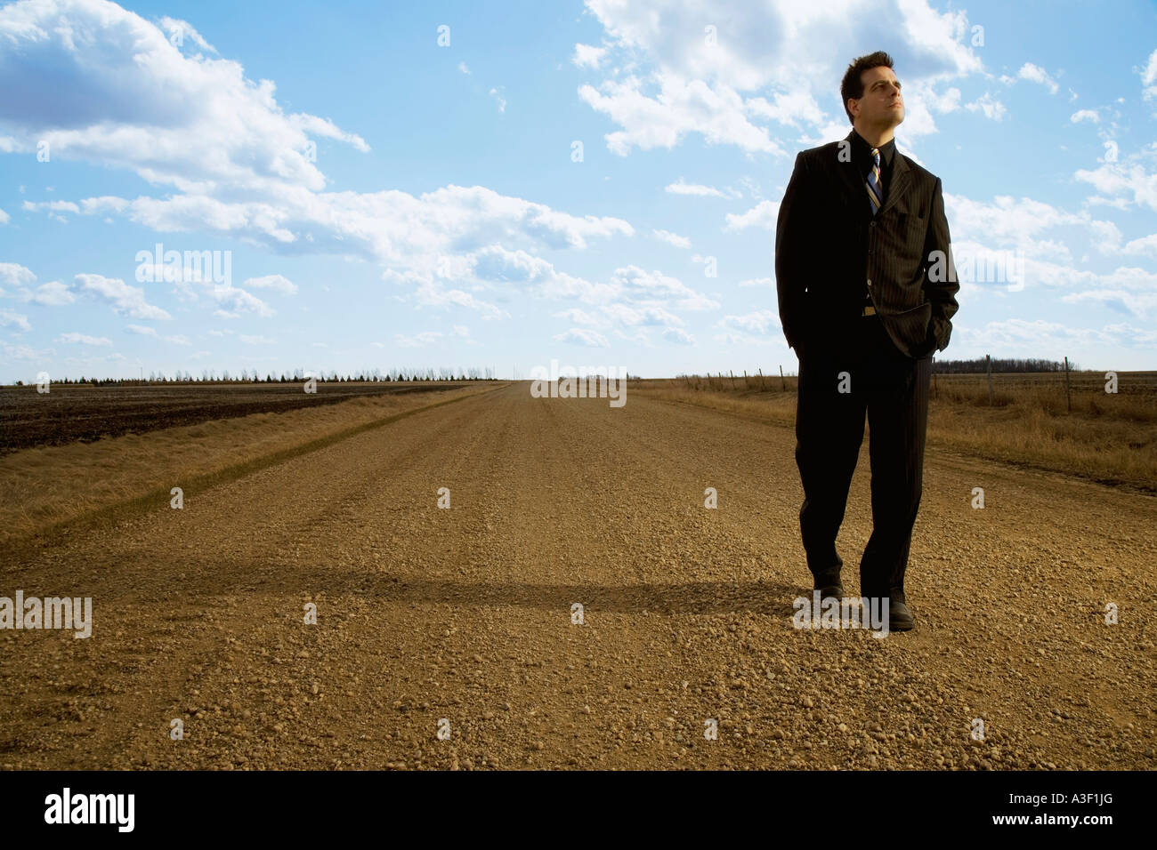 Young man walking on road Stock Photo - Alamy
