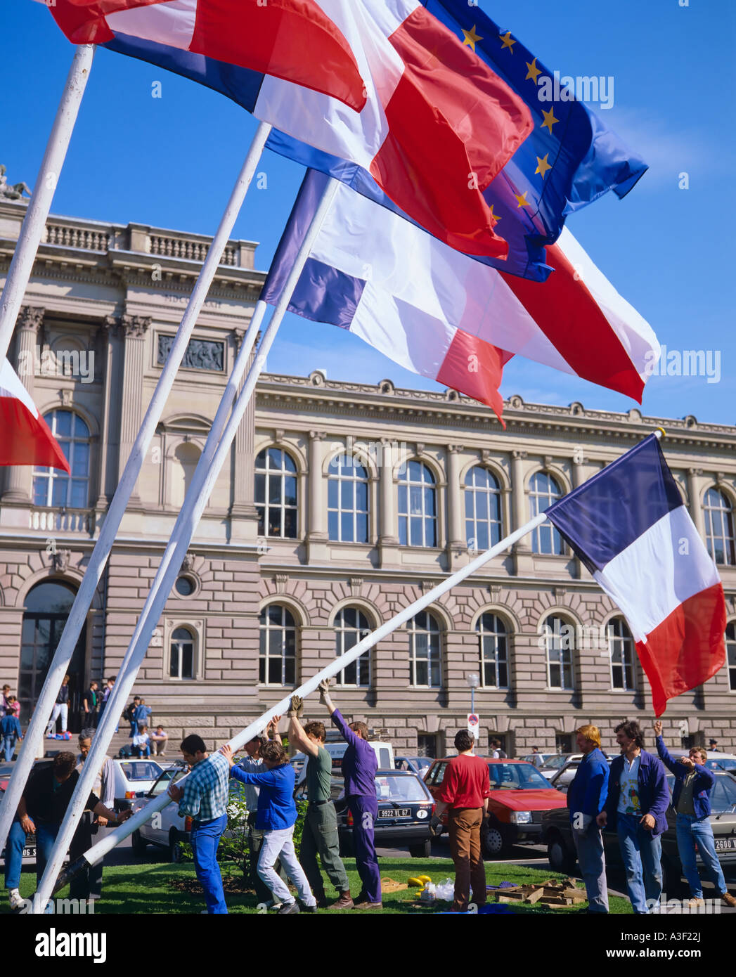 WORKERS RAISING FRENCH FLAG POLE IN FRONT OF UNIVERSITY STRASBOURG ...