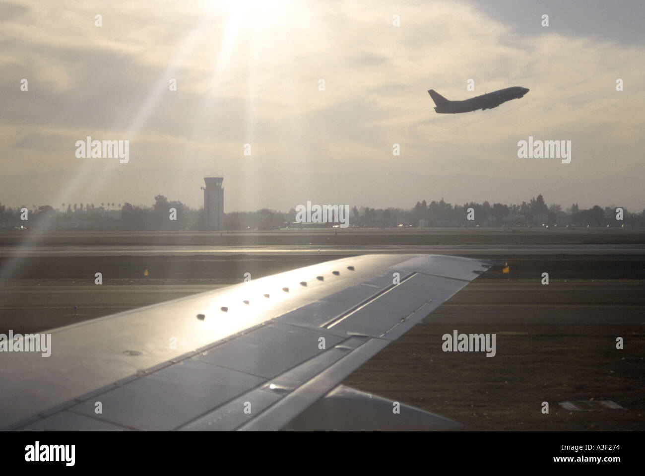 View of plane taking off through window of plane on ground United ...