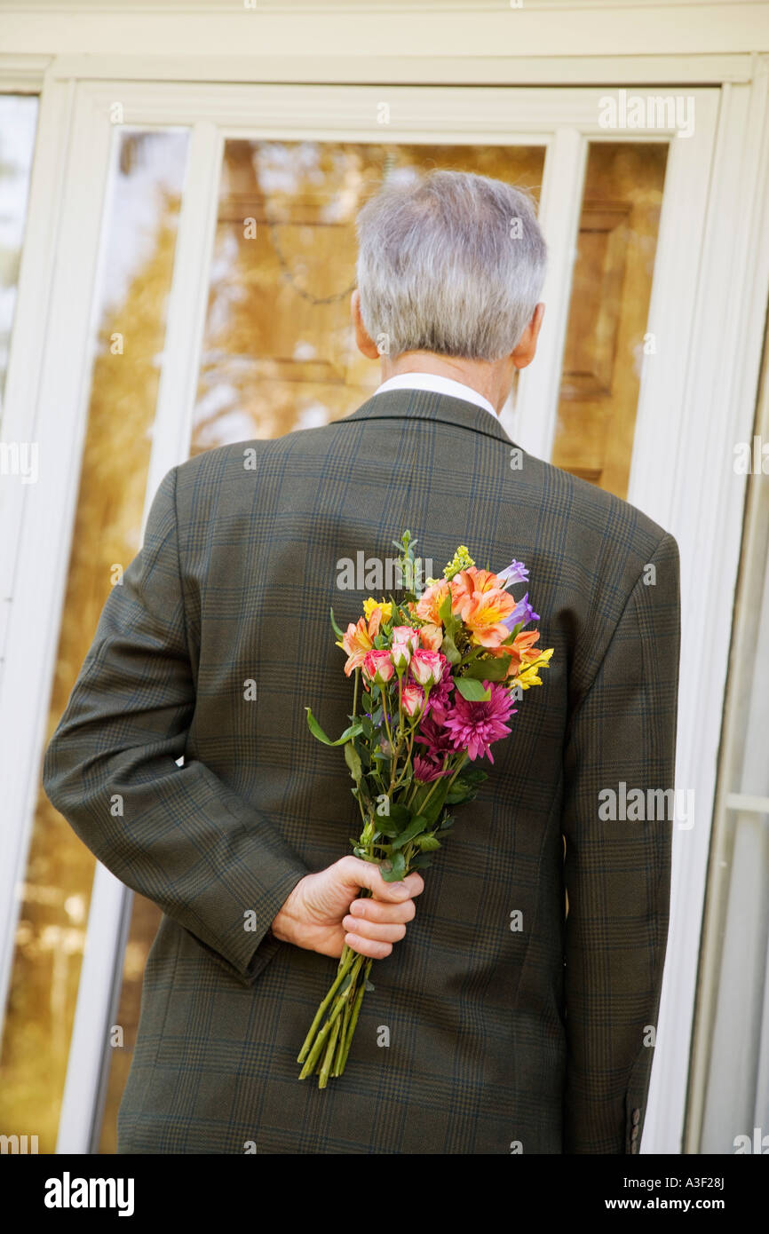 Man bringing flowers Stock Photo - Alamy