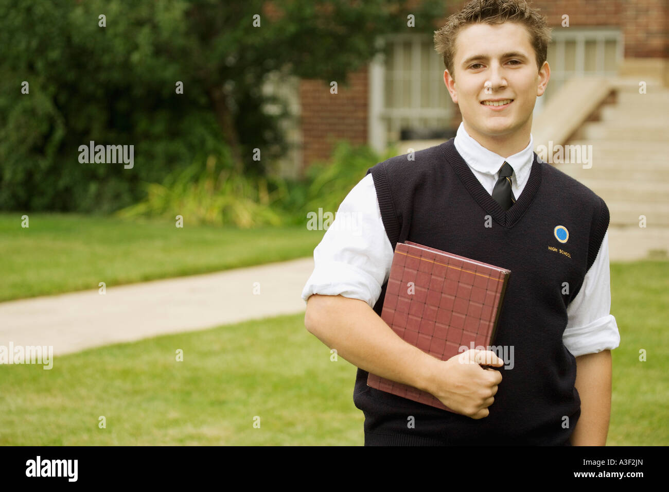 Young man outside of school Stock Photo - Alamy