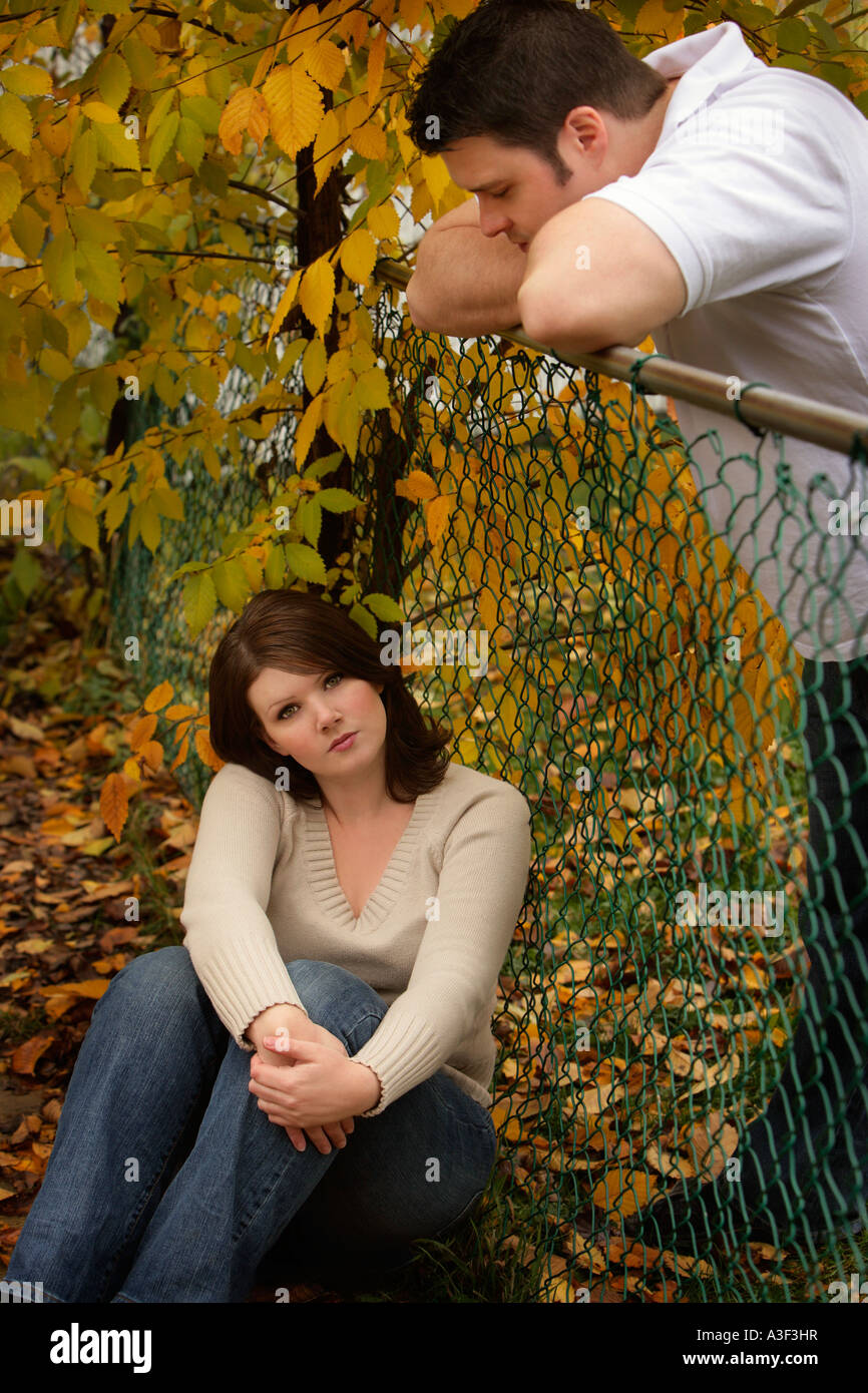 Neighbor looking over fence Stock Photo - Alamy