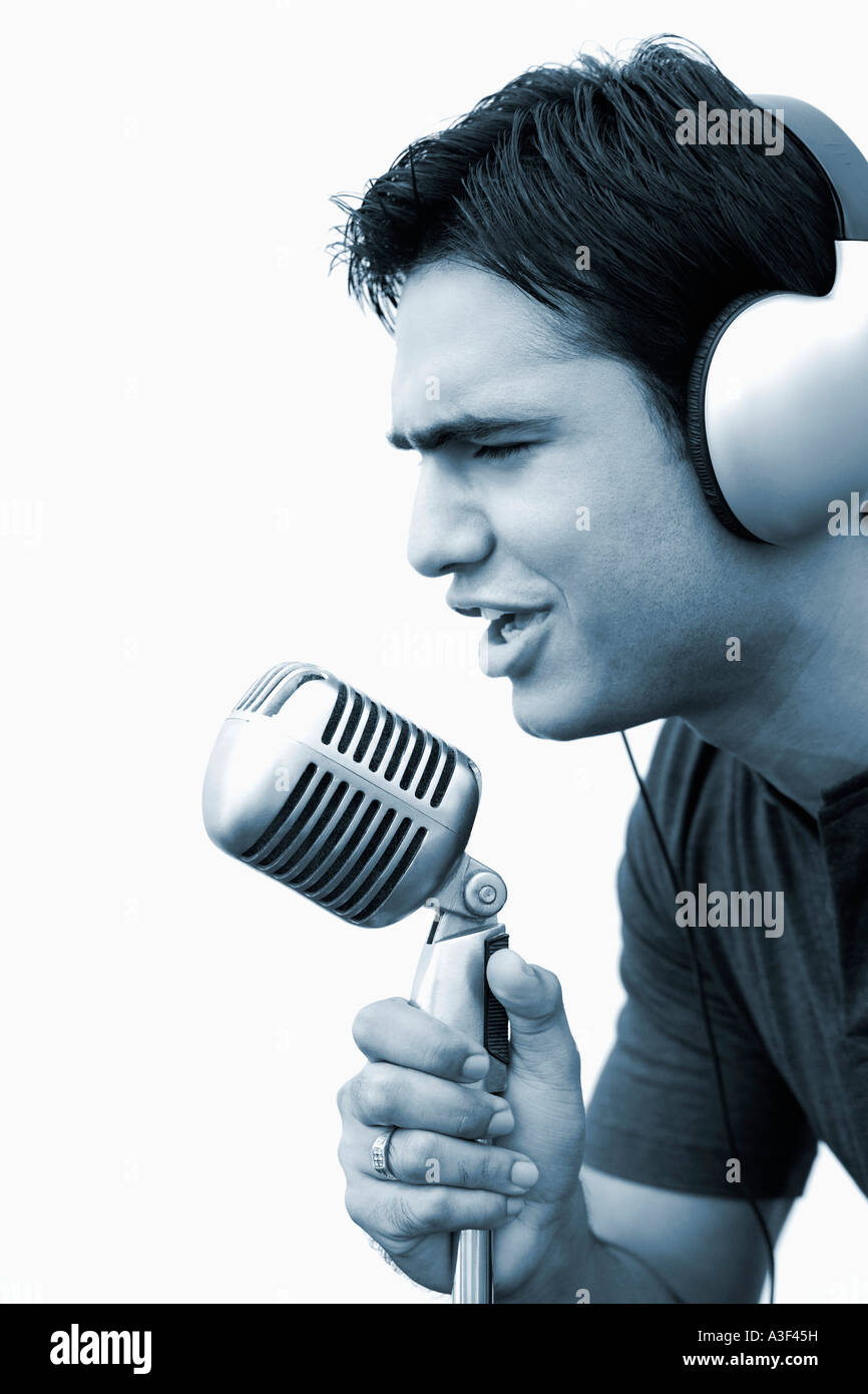Close-up of a young man singing into a microphone Stock Photo - Alamy