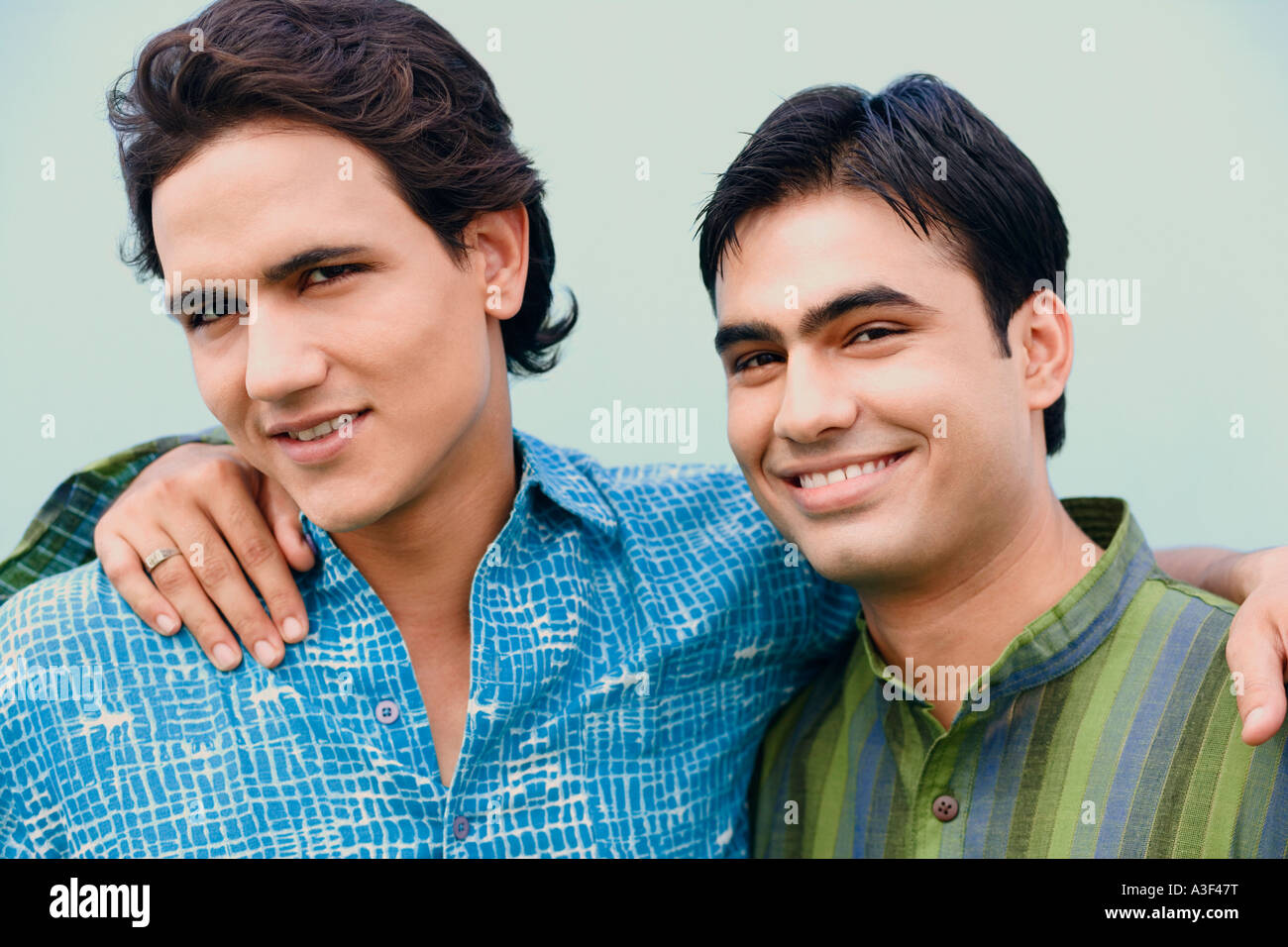 Portrait of two young men smiling Stock Photo - Alamy