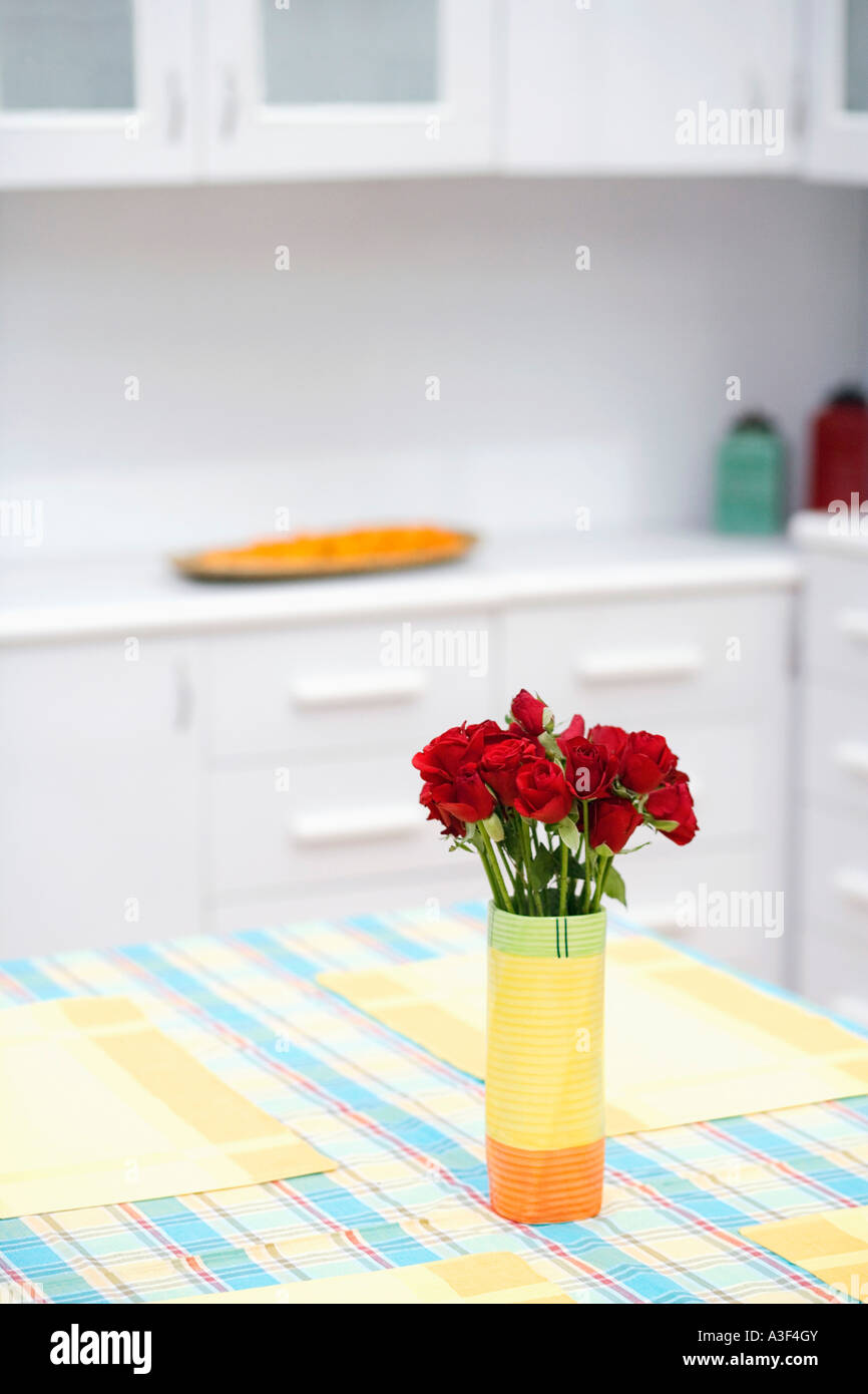 Roses in a vase on the dining table Stock Photo - Alamy