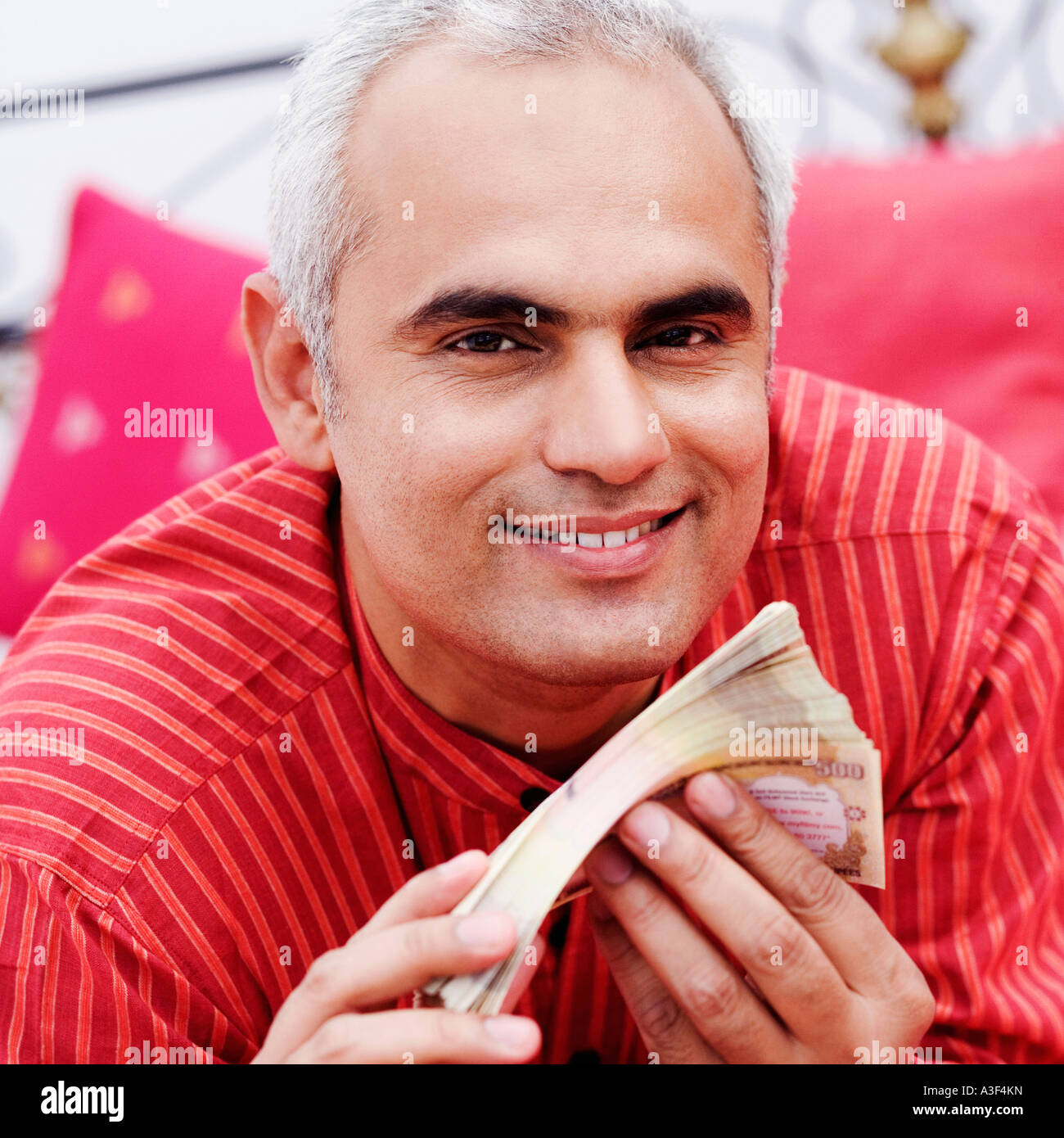 Happy smiling indian man holding indian money hi-res stock photography ...