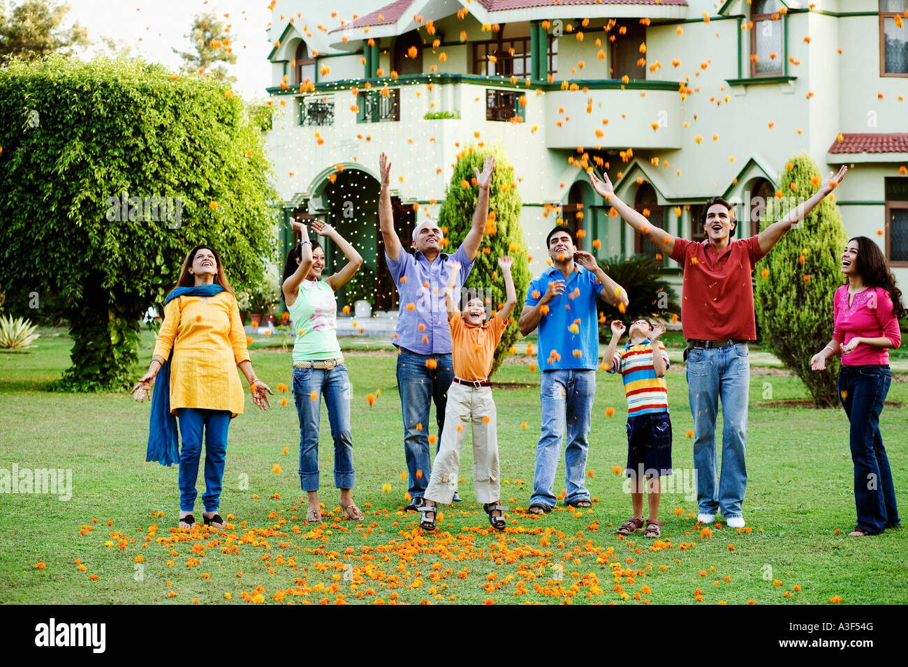 Group of people tossing flowers Stock Photo - Alamy