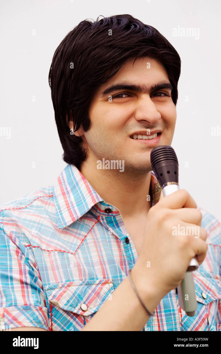 Indian man singing microphone smiling hi-res stock photography and images - Alamy