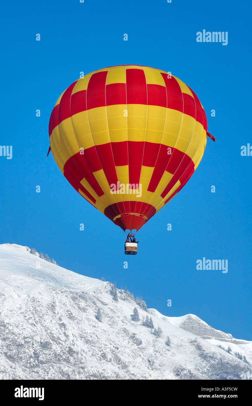 A hot-air balloon flying over snow-covered mountains Stock Photo - Alamy