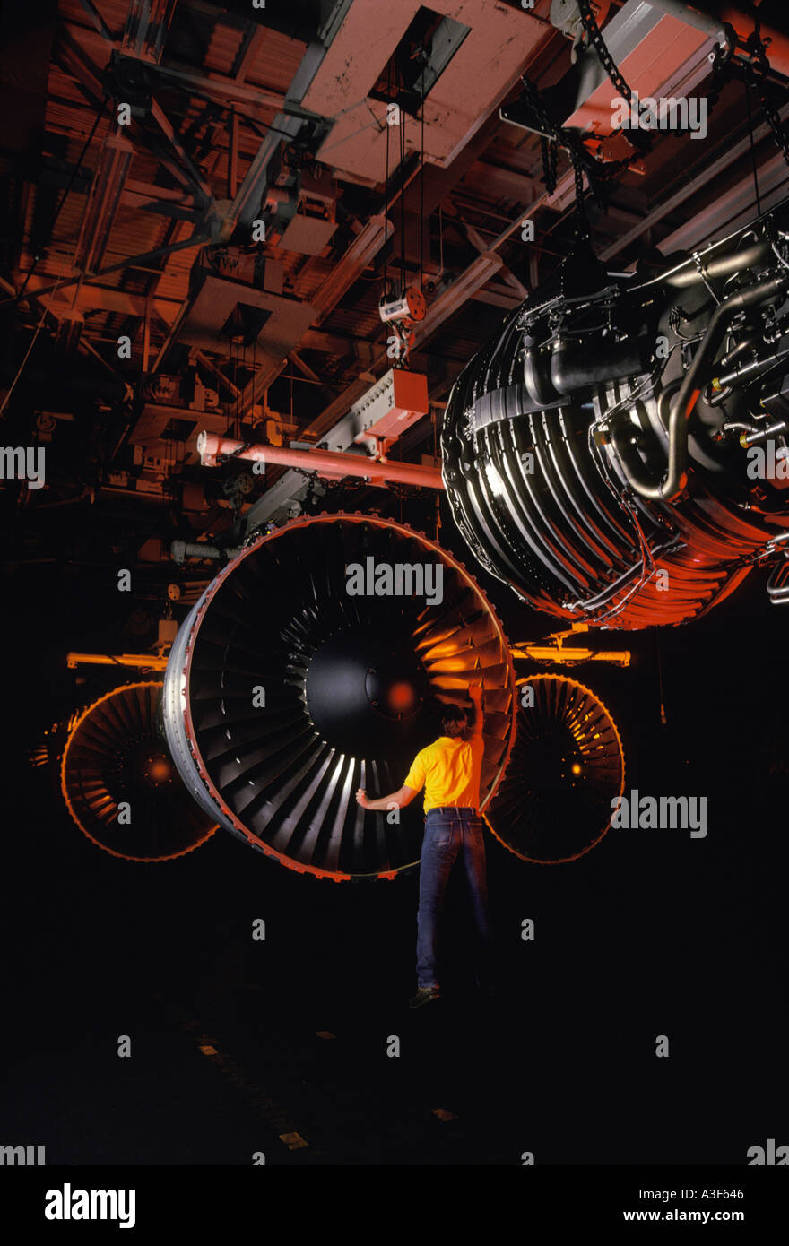 technician working on jet engine at Pratt and Whitney side of engine ...