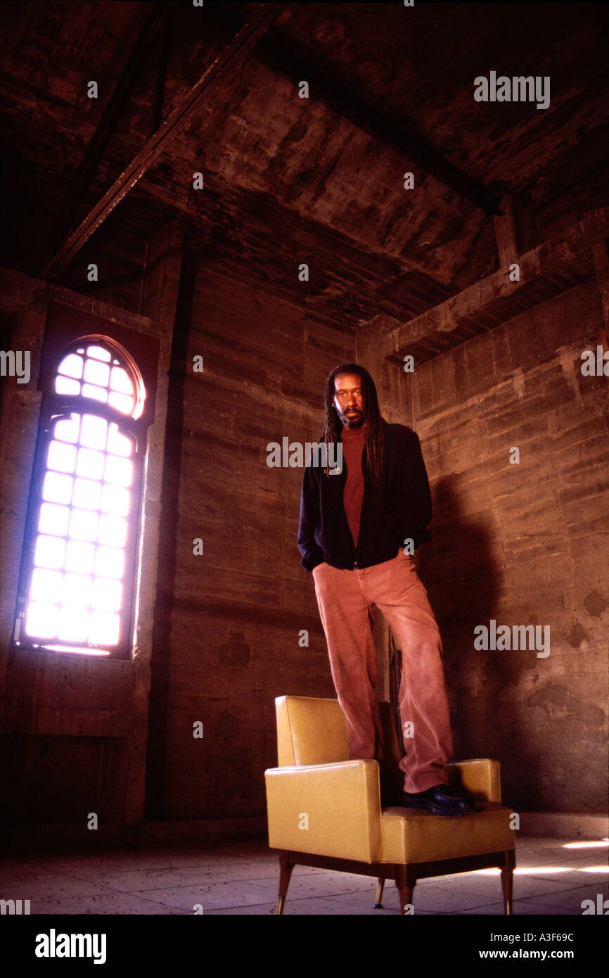 man of color standing on chair in tower Stock Photo - Alamy