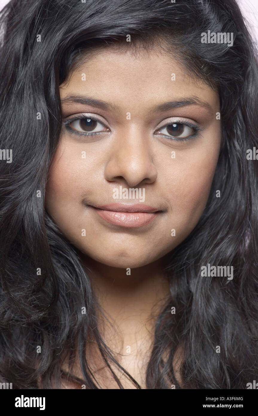 Portrait of a young woman smirking Stock Photo - Alamy