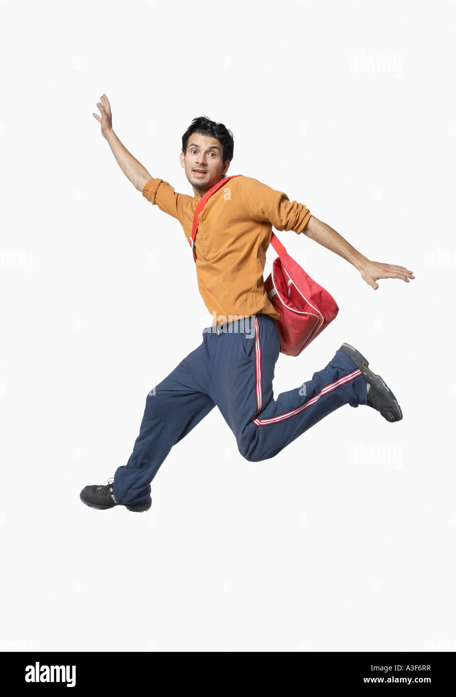 Portrait of a young man jumping Stock Photo - Alamy