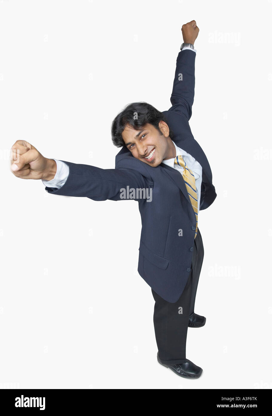 High angle view of a businessman standing with his arms raised and ...