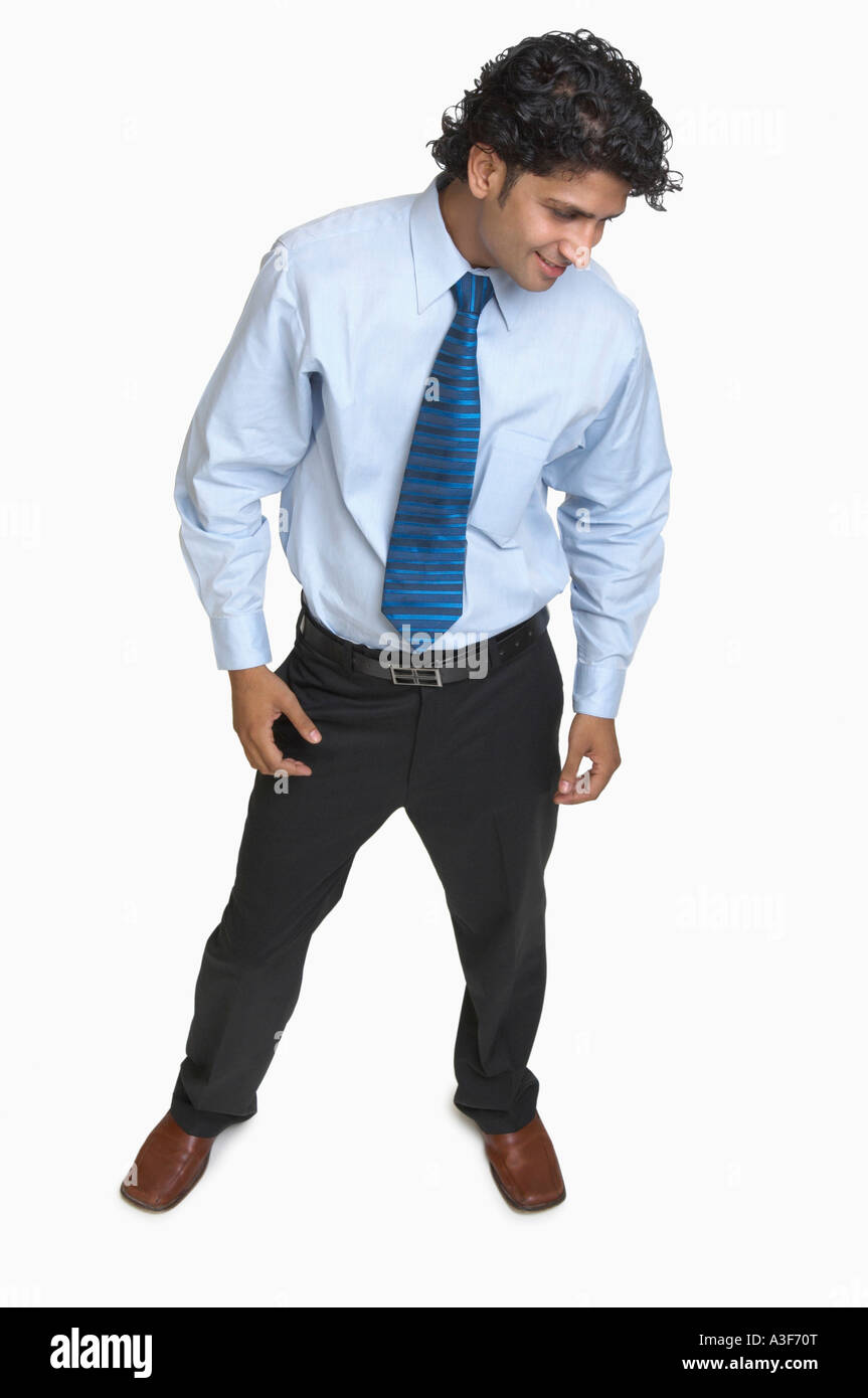 Young man standing and smiling Stock Photo - Alamy