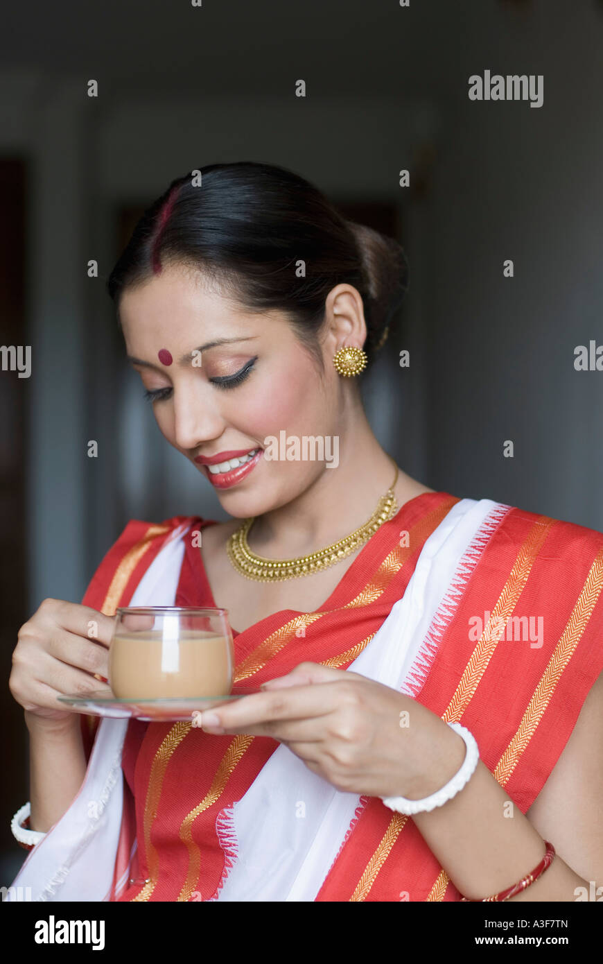 Close-up of a young woman holding a cup of tea Stock Photo - Alamy