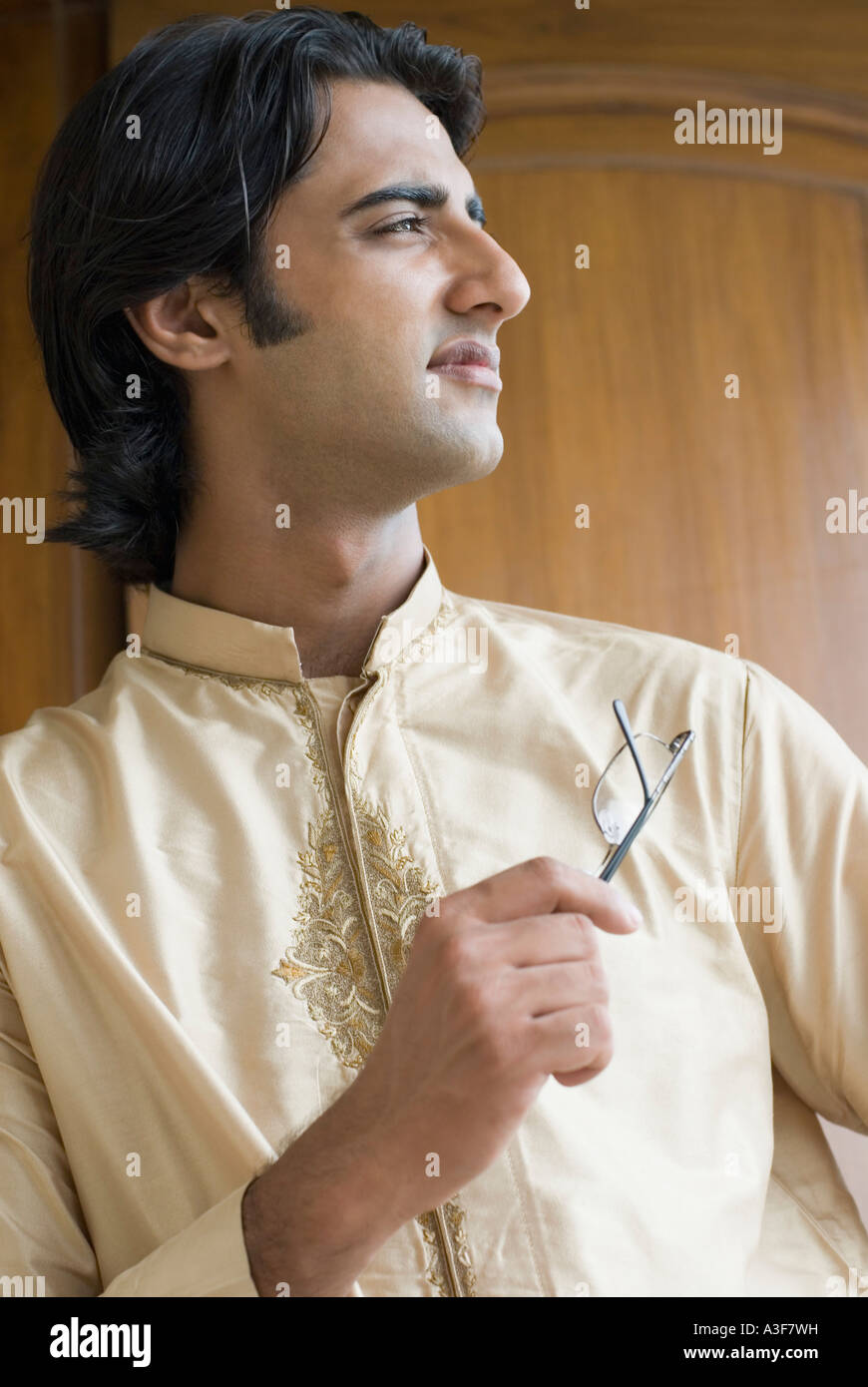 Close-up of a young man holding eyeglasses Stock Photo - Alamy