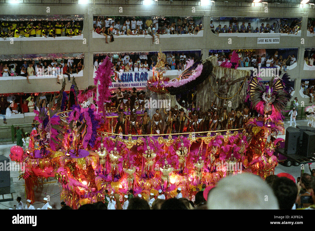 Men and women in costume dancing parading on a float in Rio Carnival ...